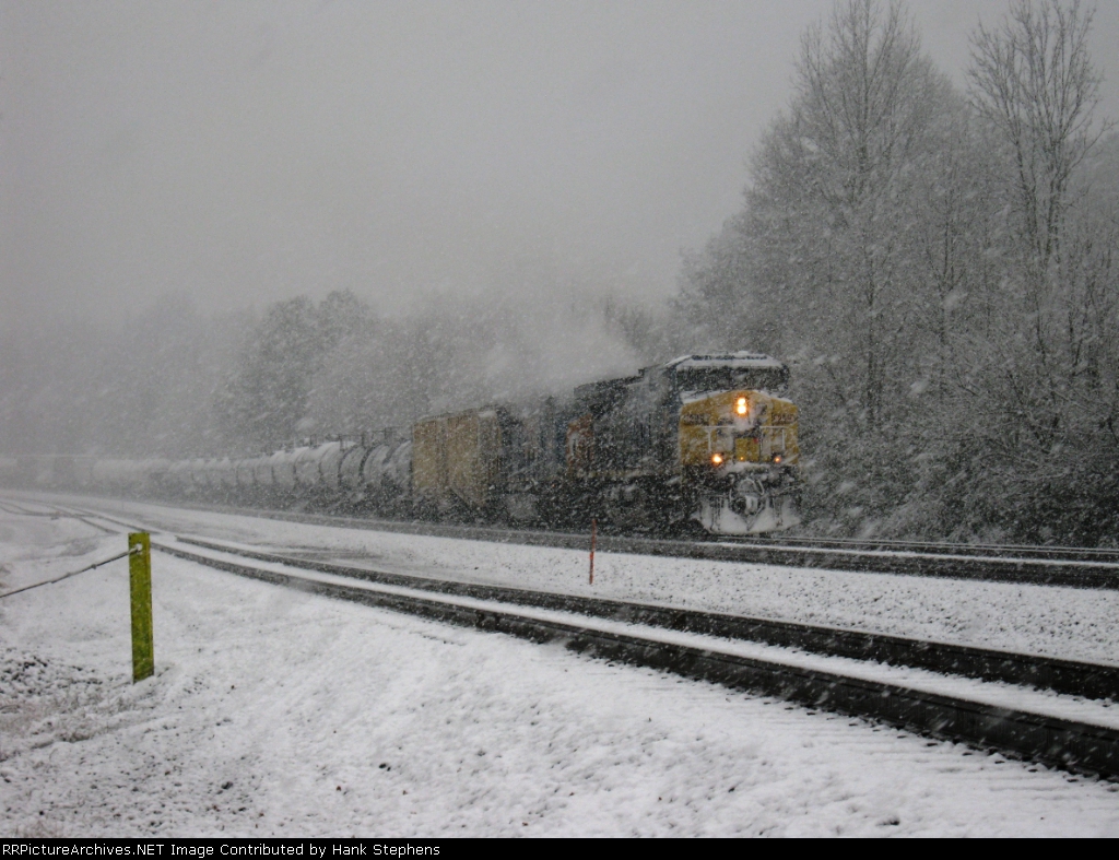 CSX Q608 gets going after waiting for over an hour in the heavy snow. Steam billows from the GE ...